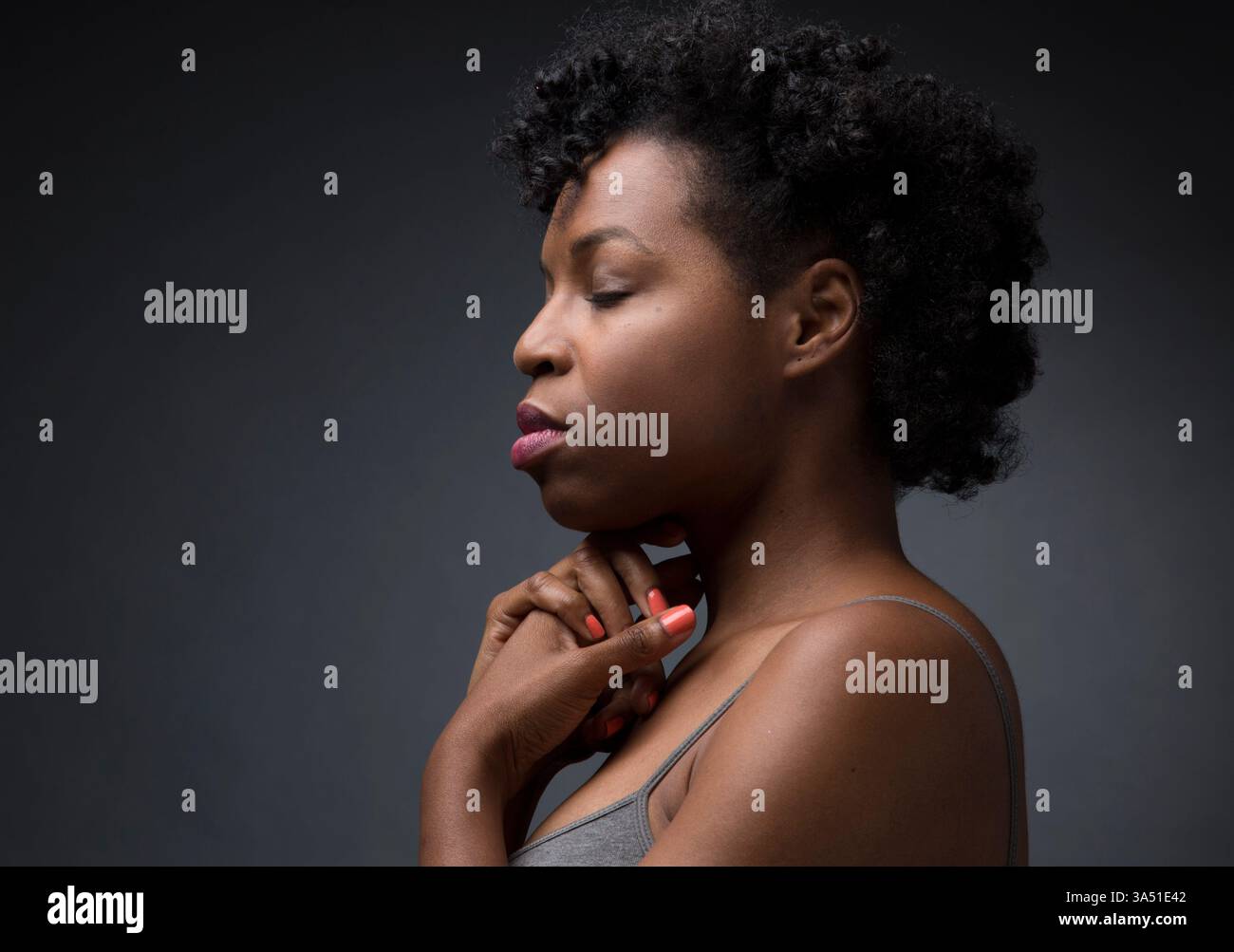 Serious Black woman deeply thinking praying meditating stressed ...