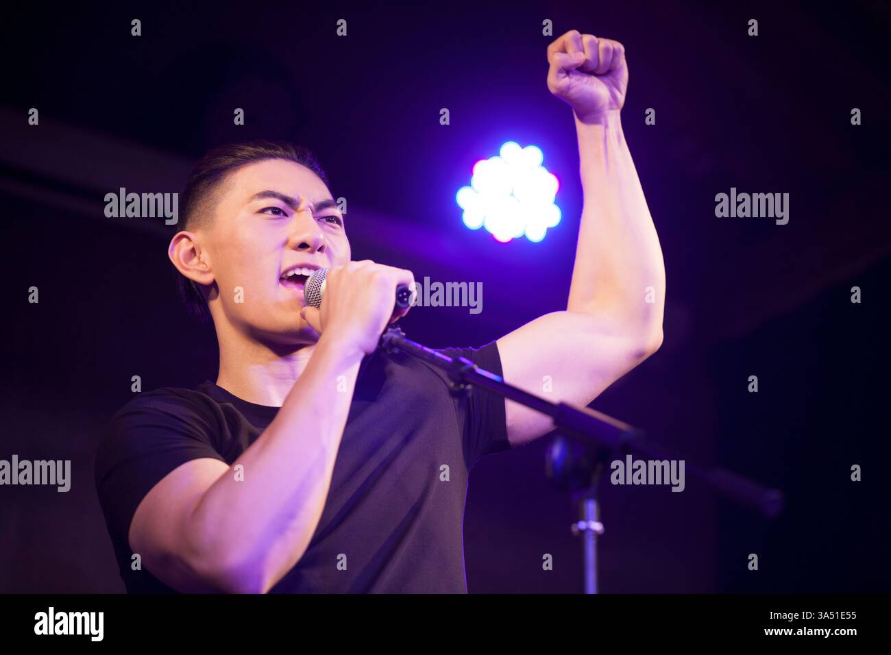 Young Chinese man singing on stage Stock Photo - Alamy
