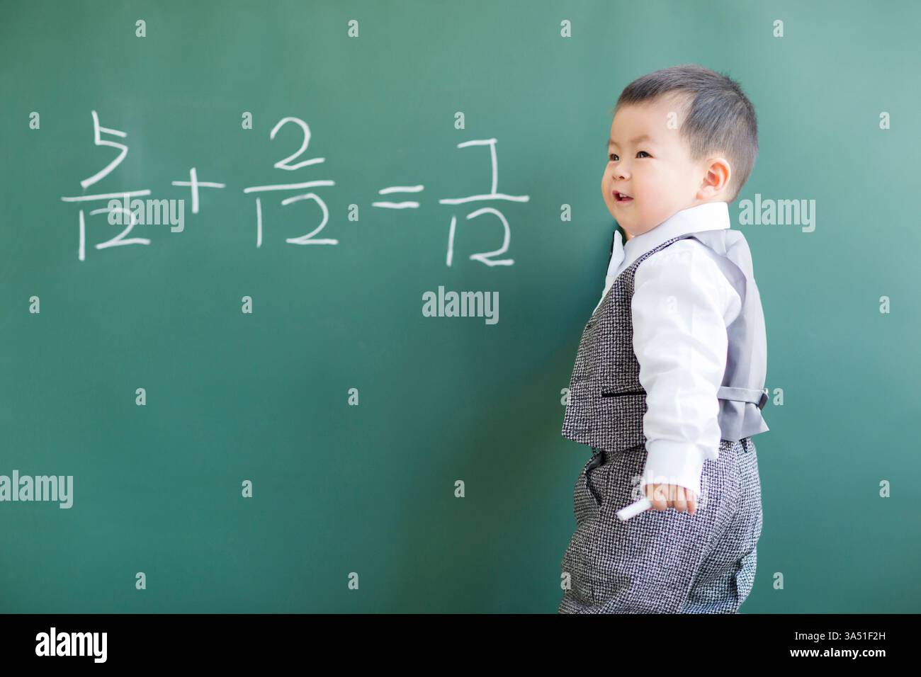 Cute Chinese baby doing mathematics on blackboard Stock Photo - Alamy