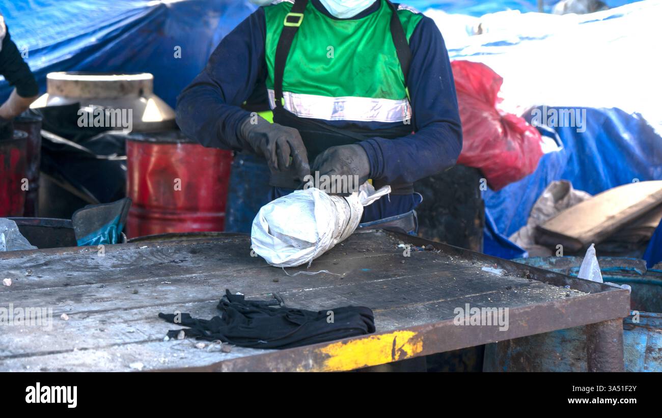 Unrecognizable Latino worker recycling plastic in a plant with ...