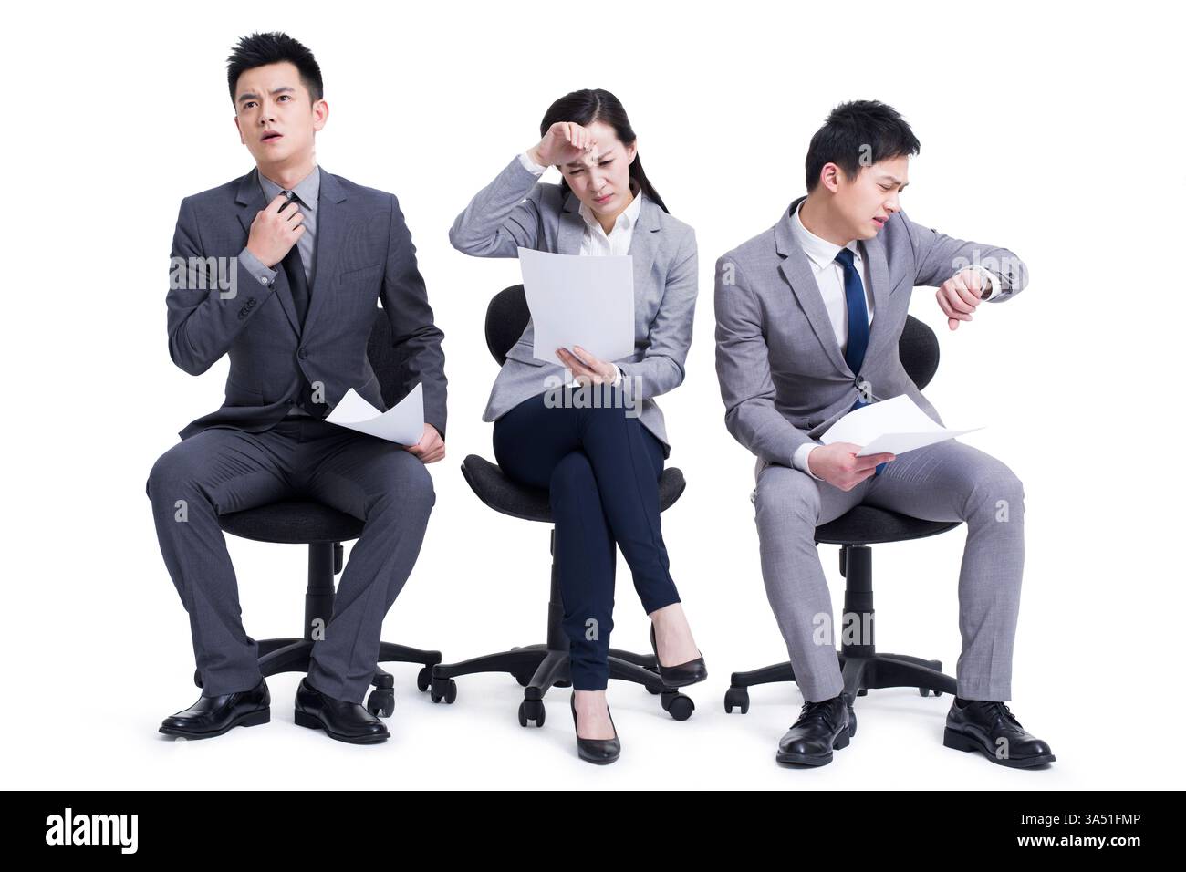 Anxious Chinese applicants waiting for interview sitting on chair ...