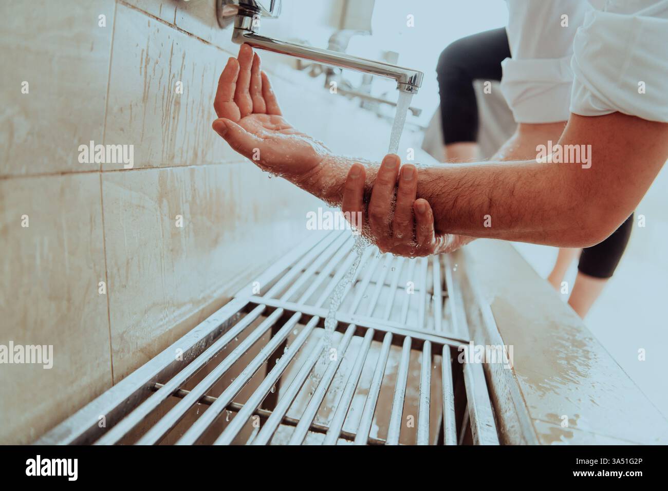 A Muslim performing ablution. Ritual religious cleansing of Muslims ...