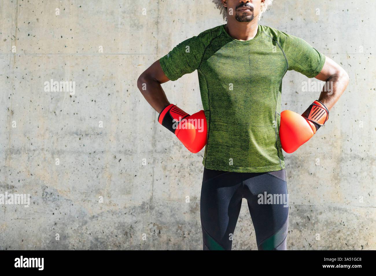 Black athlete in boxing gloves standing with hands on hips Stock Photo ...