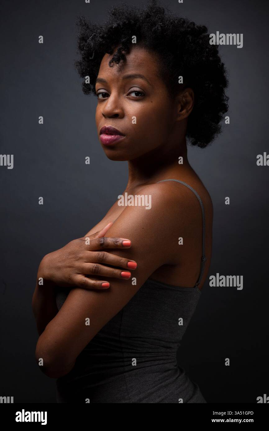 Serious Black woman deeply thinking praying meditating stressed ...