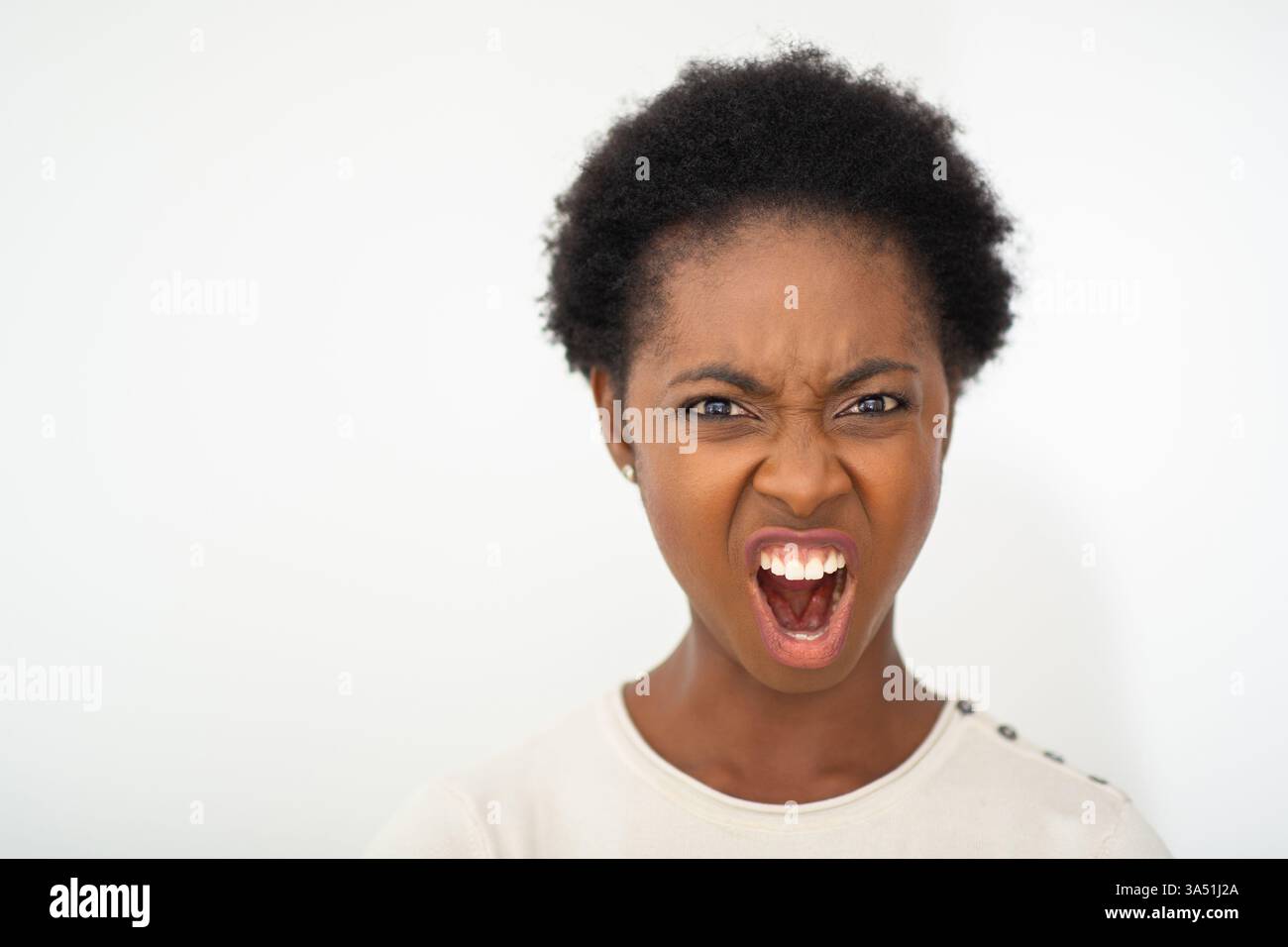 Close up portrait young African American woman shouting with mouth open ...