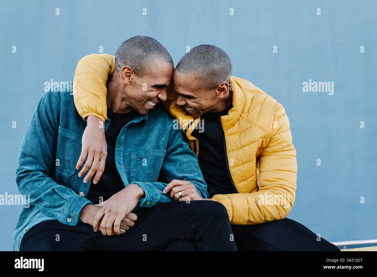 Cheerful African American men embracing each other and touching ...