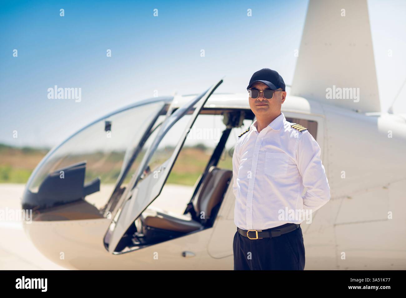 Chinese helicopter pilot standing by the vehicle Stock Photo - Alamy