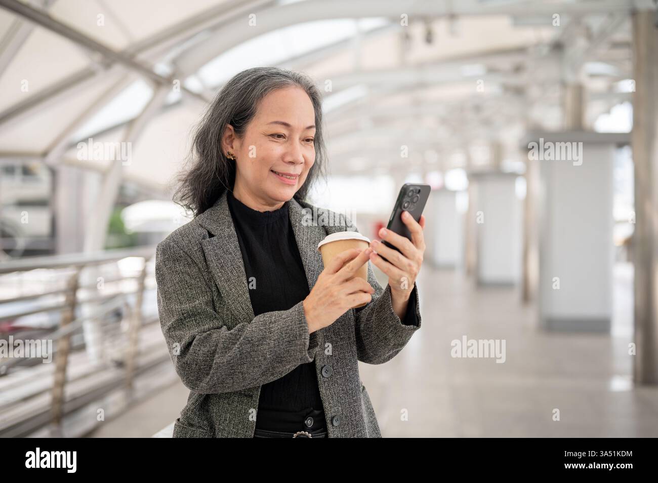 Asian woman texts on phone hi-res stock photography and images - Alamy