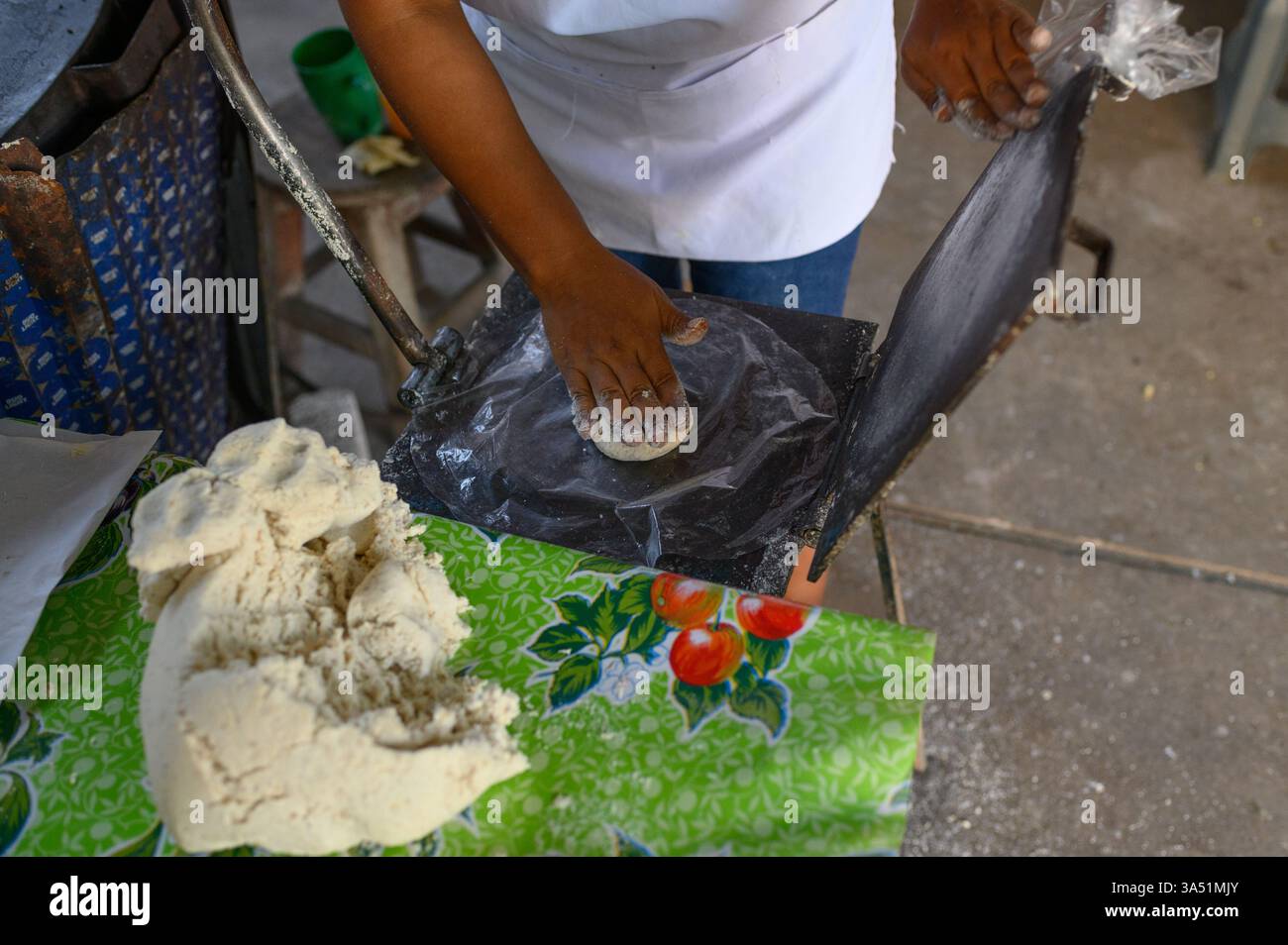 From above of crop anonymous female in casual clothes and apron cutting ...