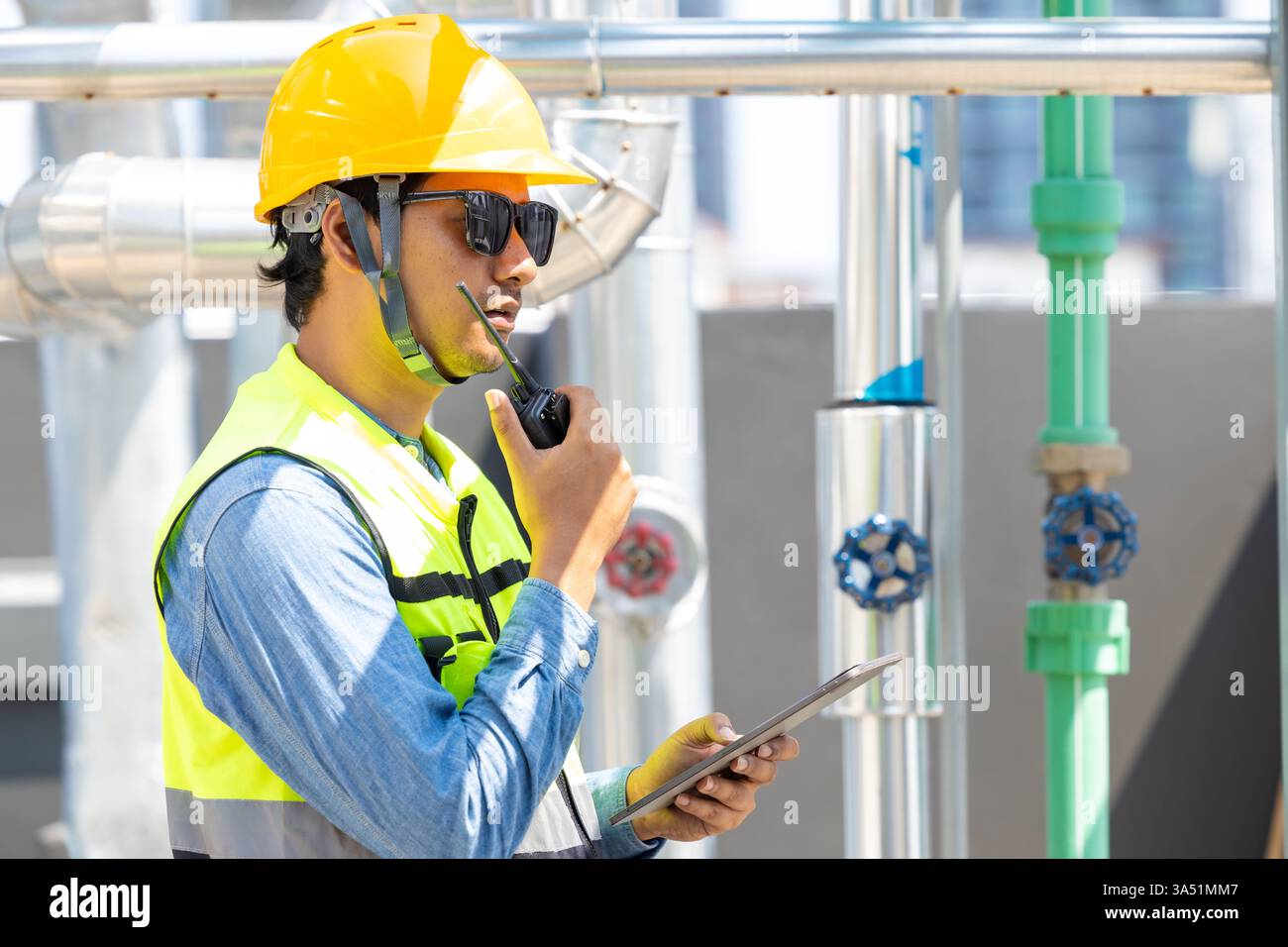 Male engineer technician checks oil and water supply systems on a ...