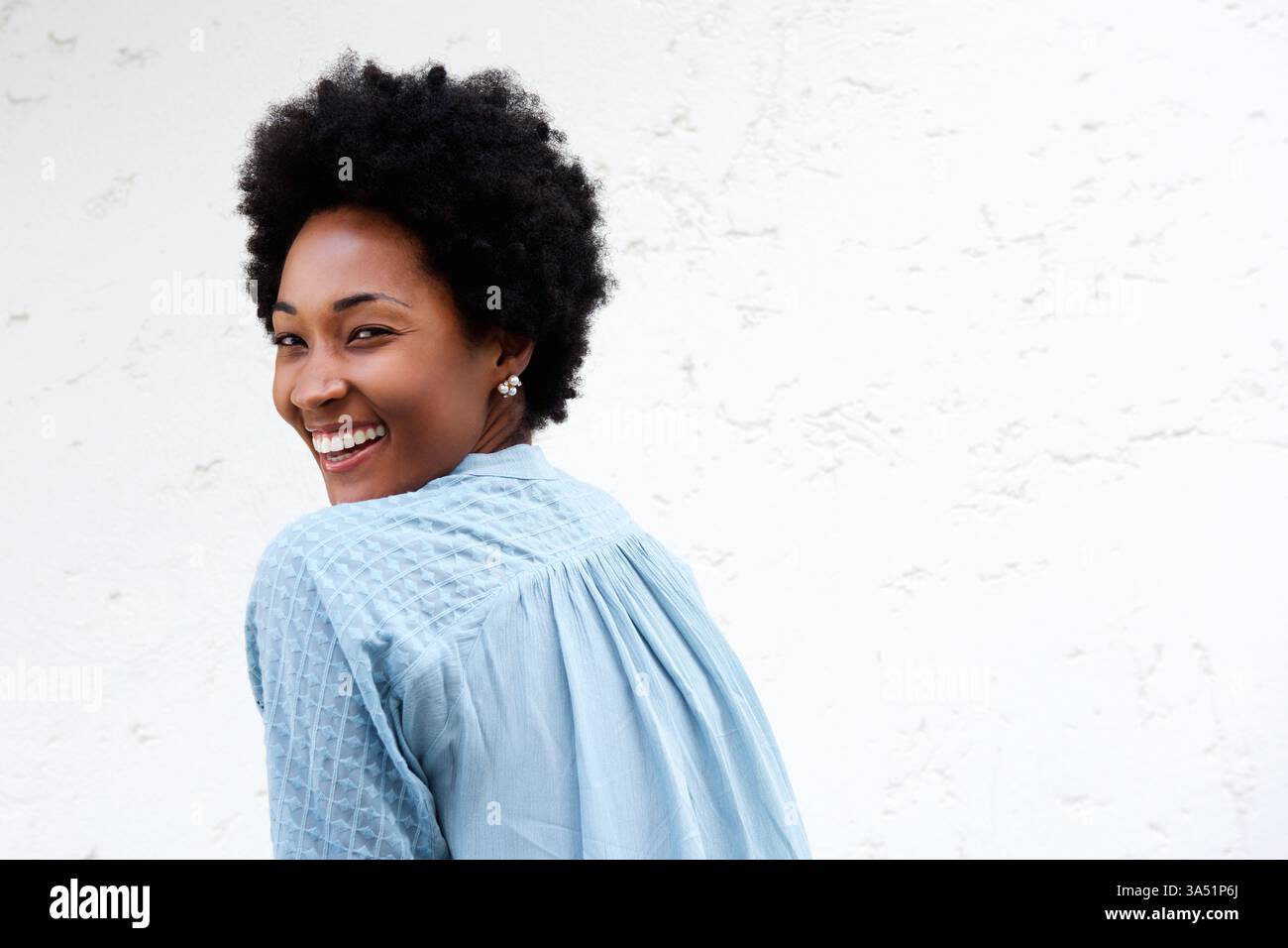 Rear view portrait of young african lady looking over shoulder and ...