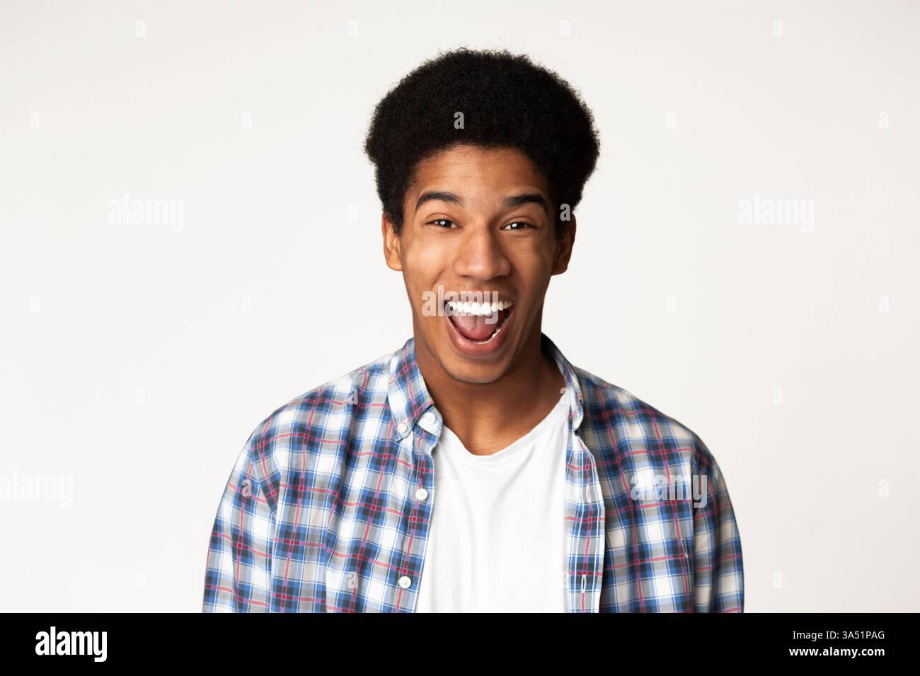 Excited man expressing great surprisment over light studio background ...