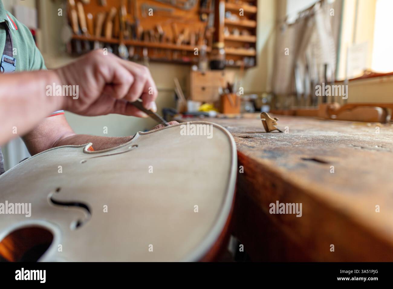 Violin maker at work in a traditional Italian workshop. An artisan ...