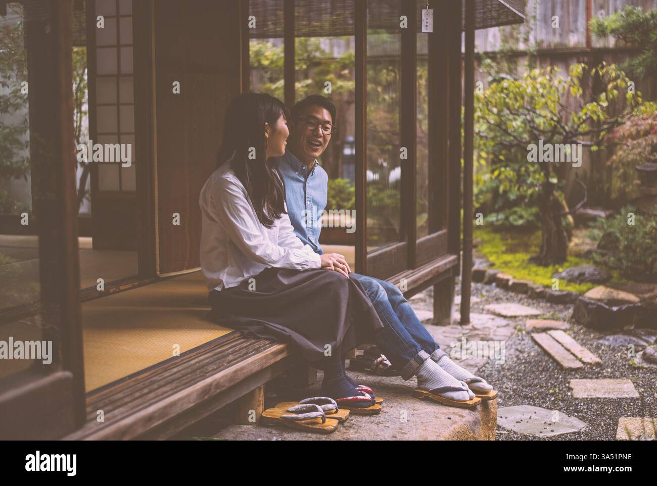 Young Japanese couple spending time at home in a warm, relaxed ...