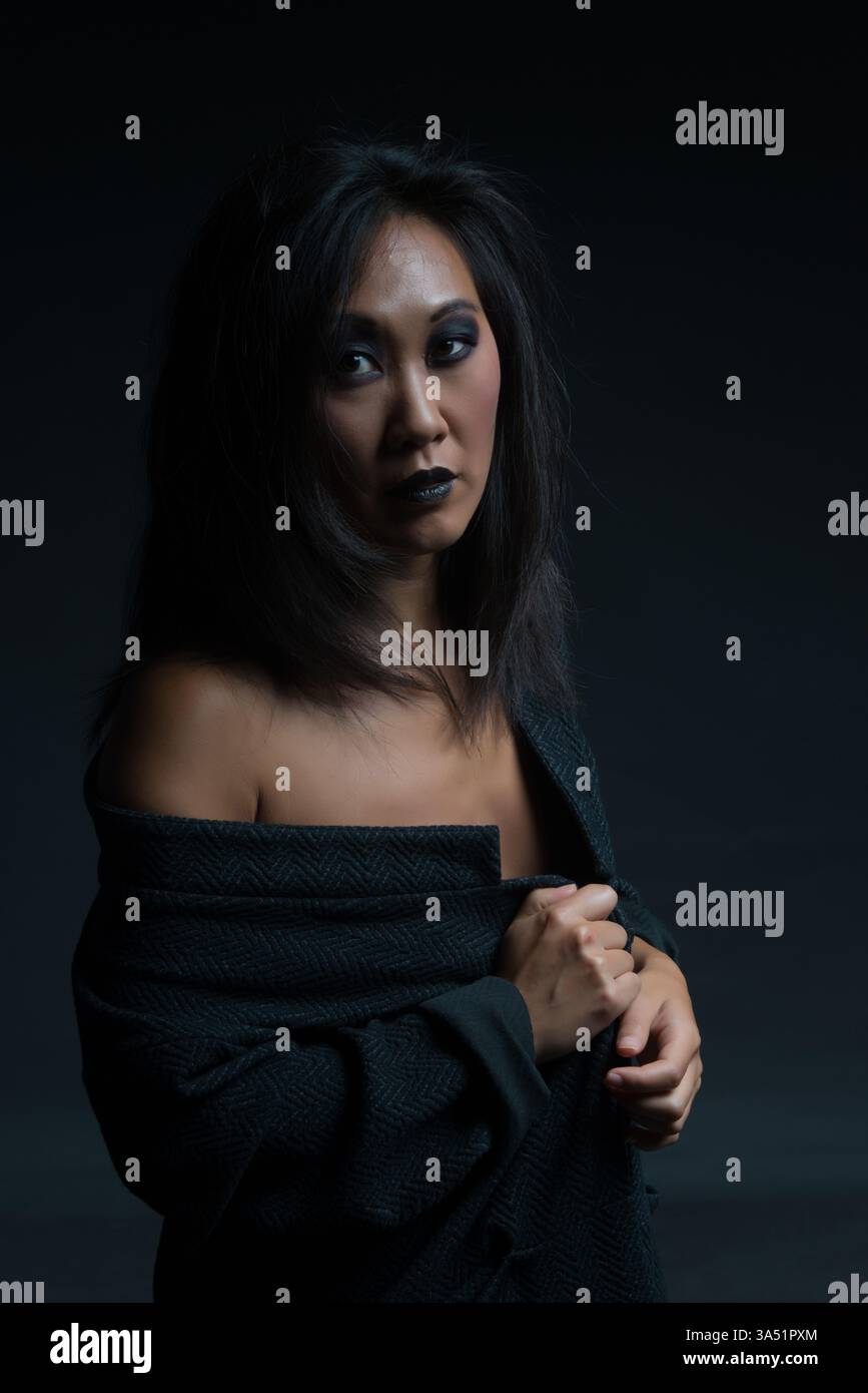 Woman standing in dark room hi-res stock photography and images - Alamy