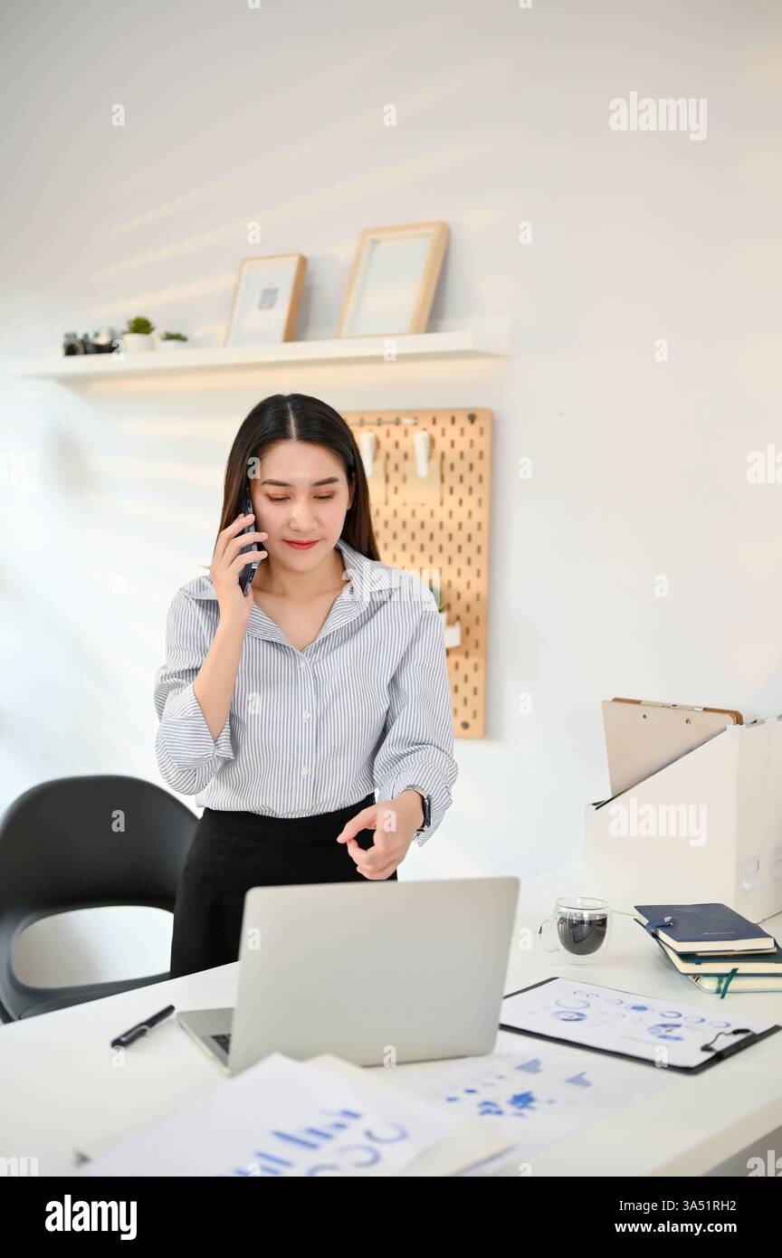 Professional and focused young Asian businesswoman or female accountant ...