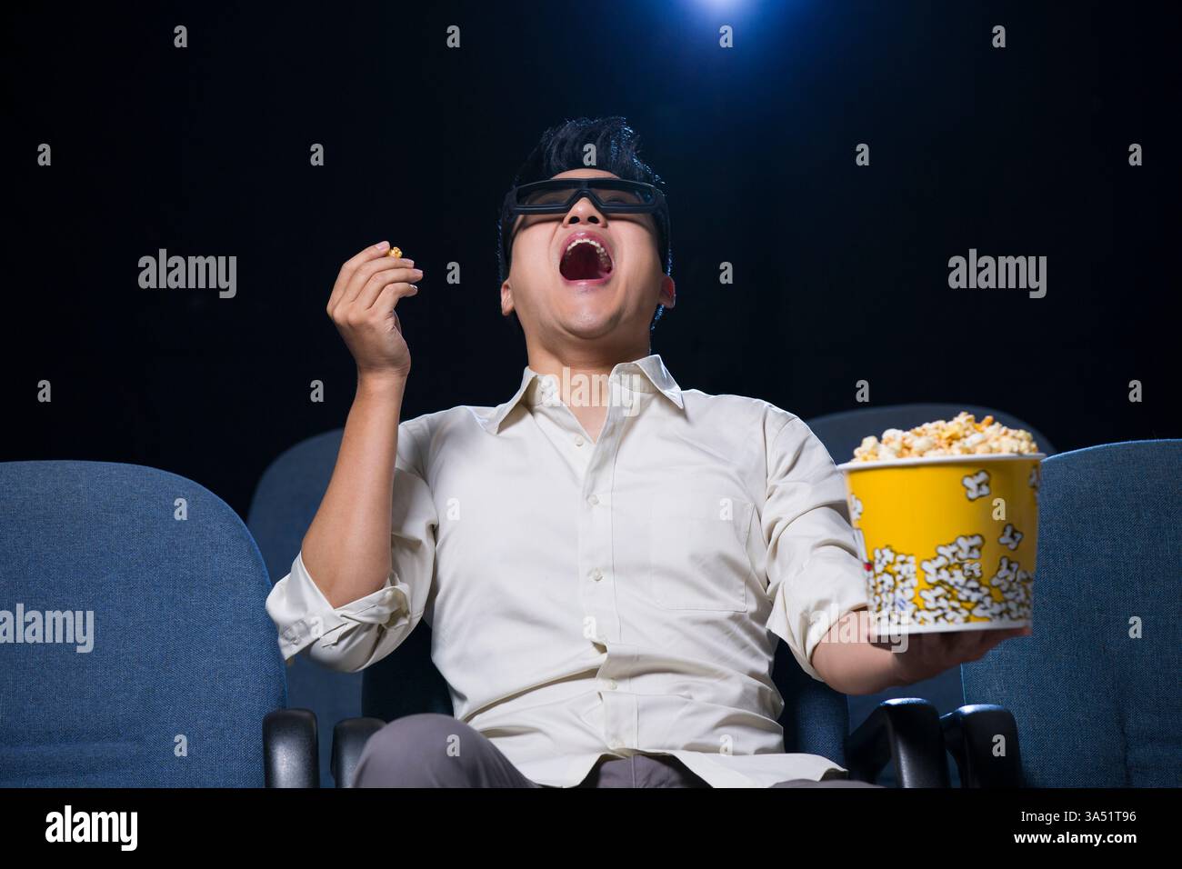 Young Chinese man watching 3D movie in cinema Stock Photo - Alamy