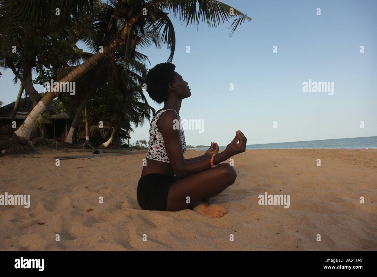 Beach side balance and elegance merge in the yoga pose of an African ...