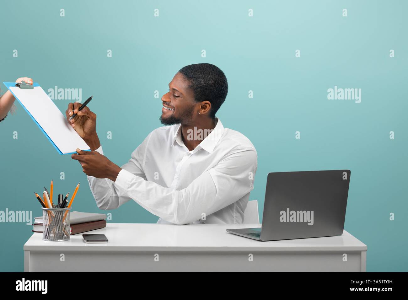 Happy african american businessman in formal wear signing contract or ...