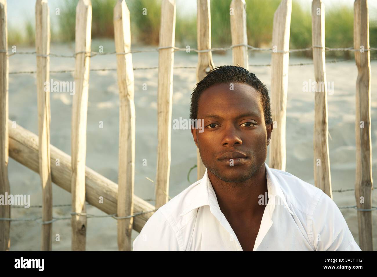 Portrait of a handsome african man sitting outdoors alone Stock Photo ...