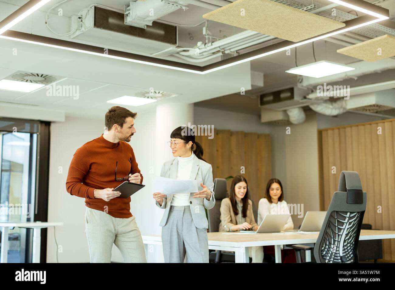 Professionals collaborate in bright office hi-res stock photography and ...