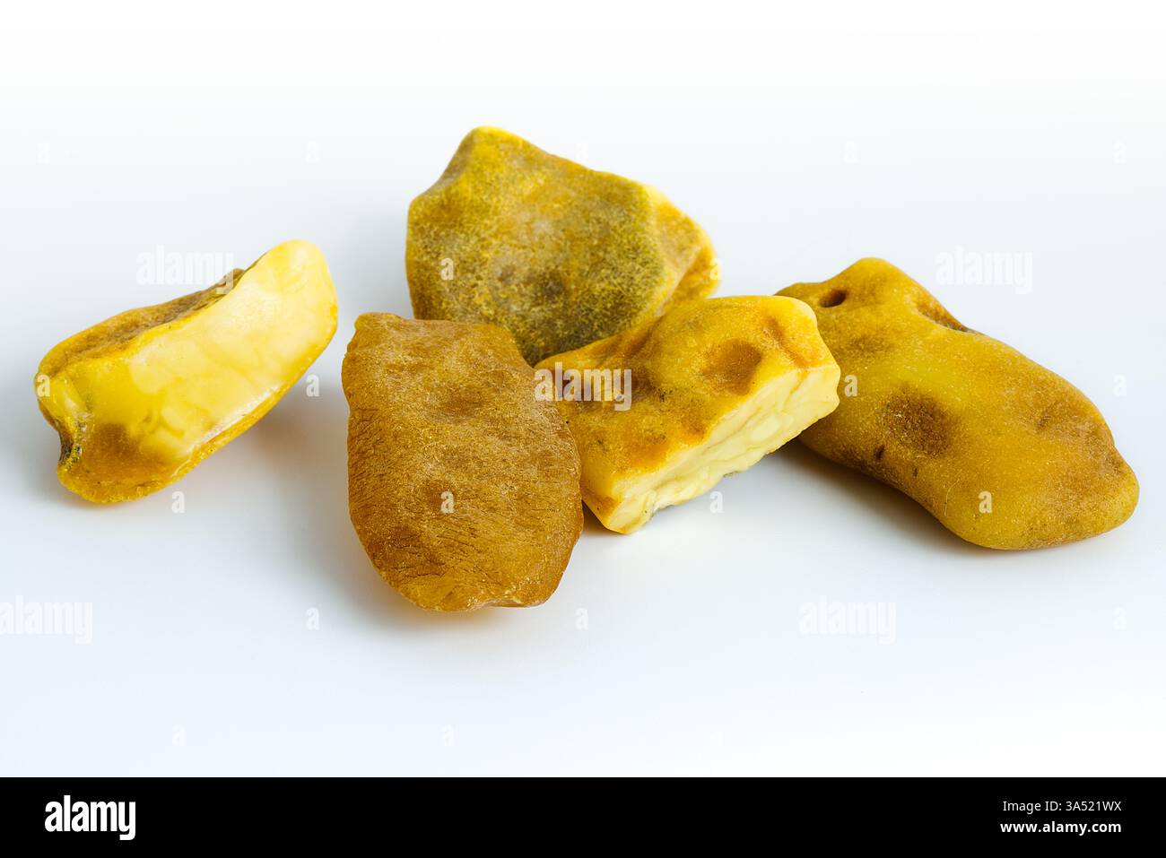 Raw Polish Baltic amber on a white backdrop is captured in this ...