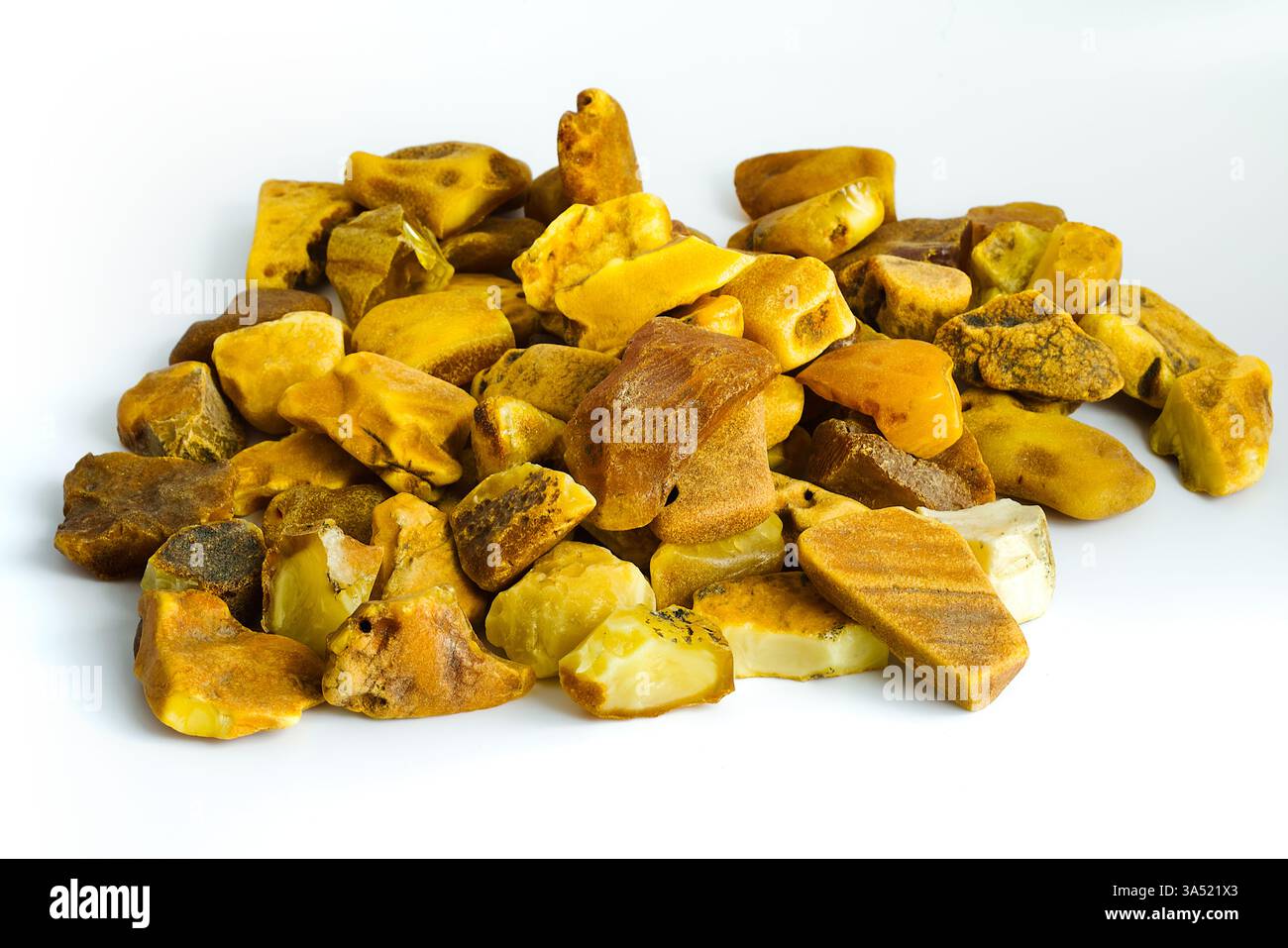 A high-resolution image of raw Polish Baltic amber on a pristine white ...