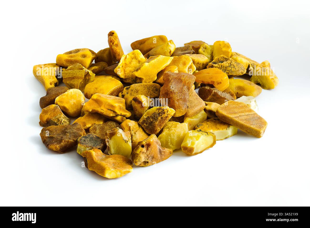 Raw, unprocessed Polish Baltic amber is displayed on a clean white ...