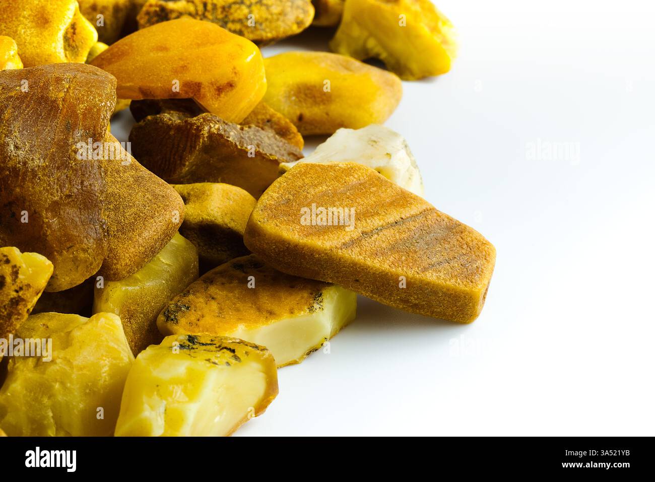 This close-up of raw Polish Baltic amber on white showcases its ...