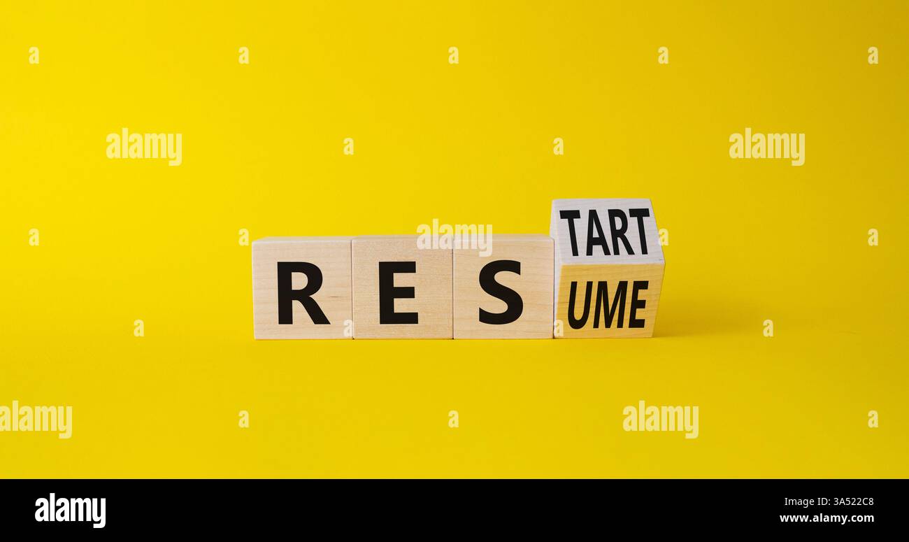 Restart and Resume symbol. Turned wooden cubes with words Resume and ...