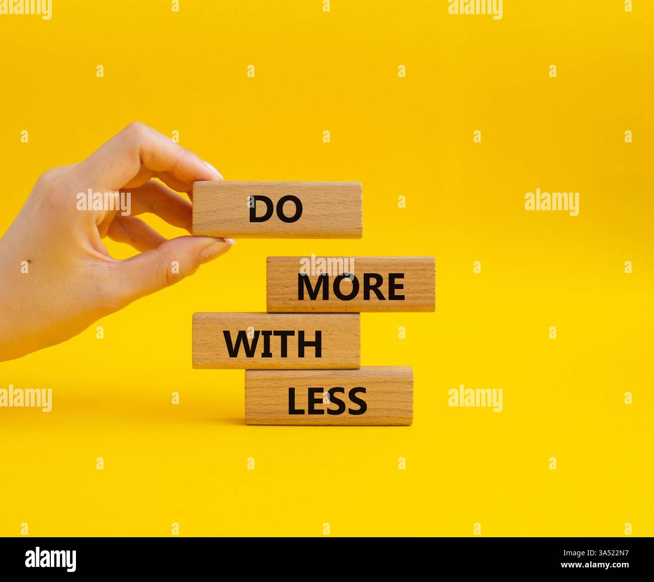 Do more with less symbol. Concept words Do more with less on wooden ...