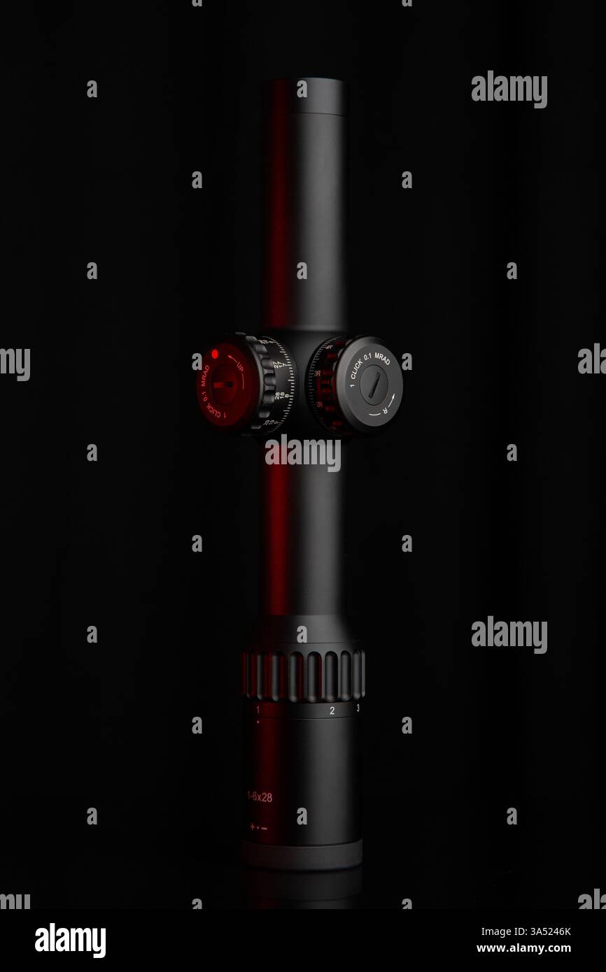 A sleek black rifle scope with red accents, featuring adjustment knobs ...