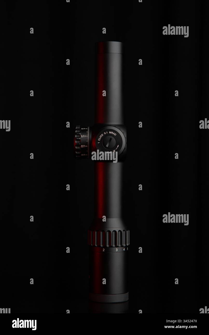 A sleek black rifle scope with red accents, featuring adjustment knobs ...