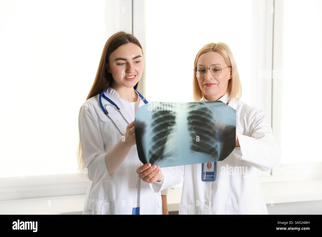Doctors examining chest x-ray near window in clinic Stock Photo - Alamy