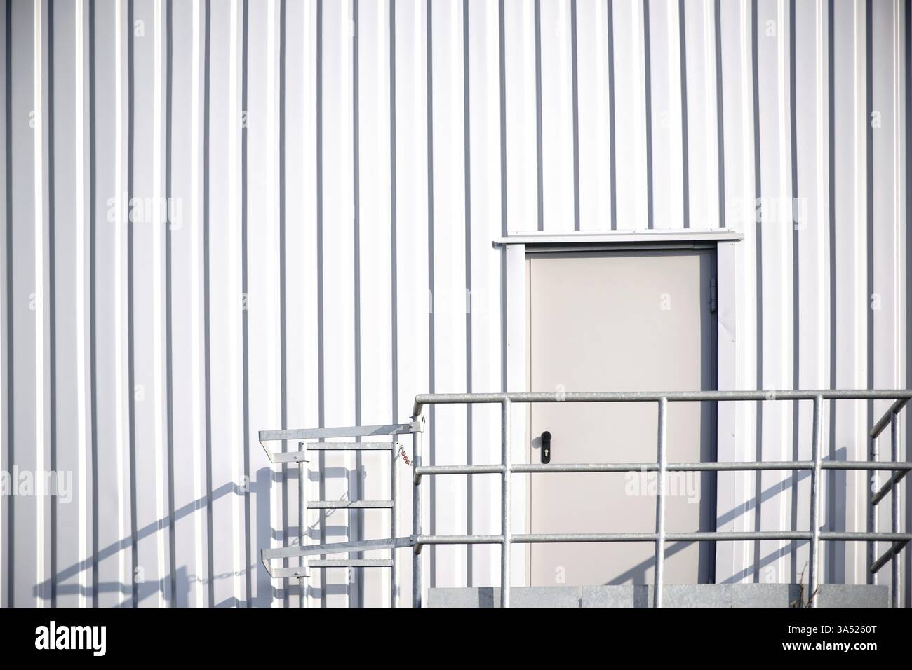 The side wall of a DIY store with an emergency exit Stock Photo - Alamy