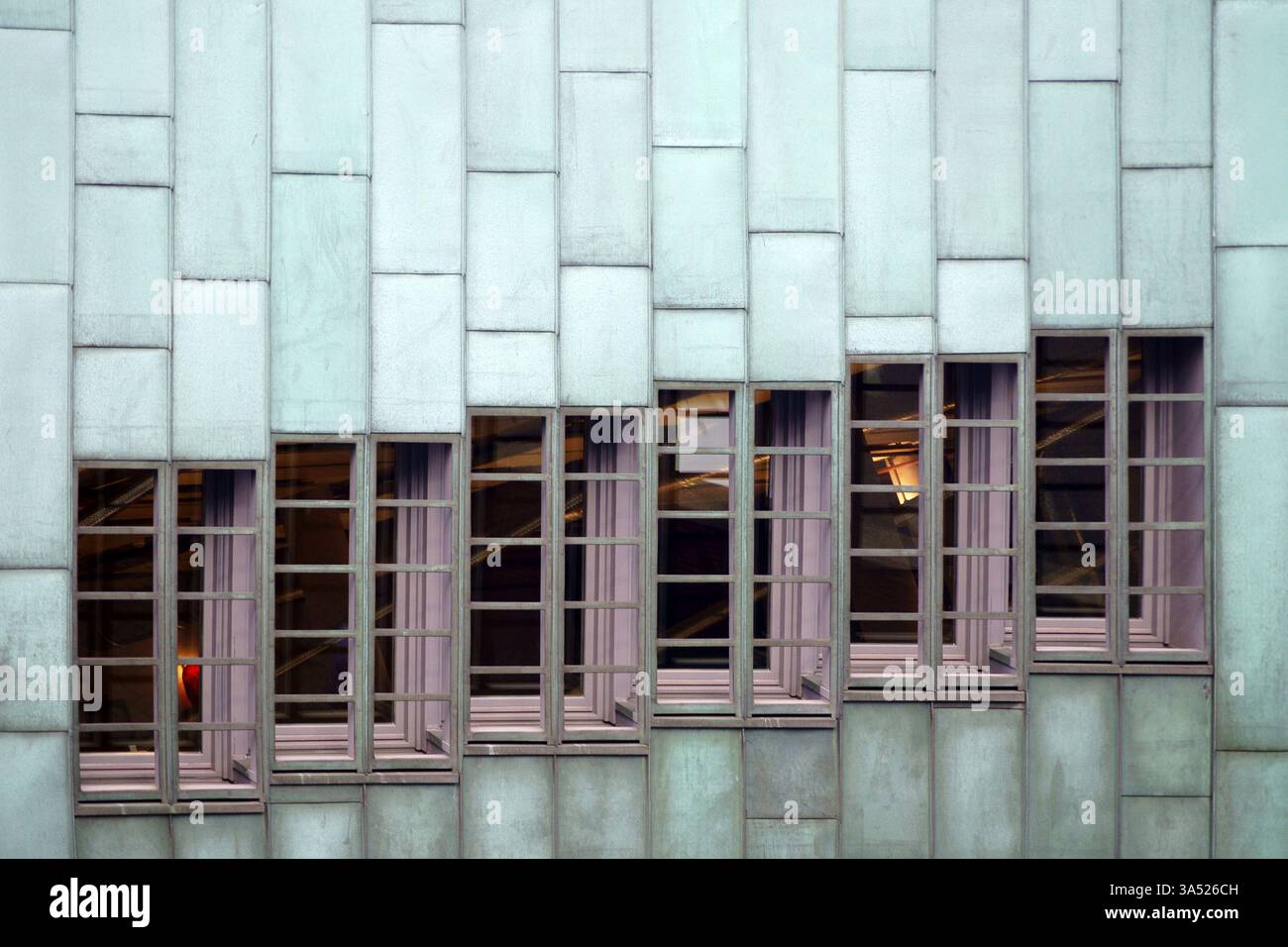 Close-up of sheet copper panelling on a facade and roof with barred ...
