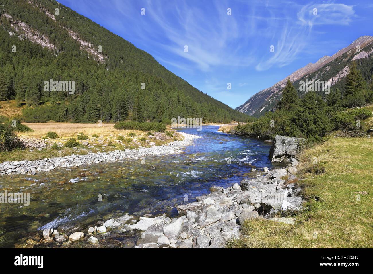 Headwaters of waterfalls - the narrow fast river among green mountain ...