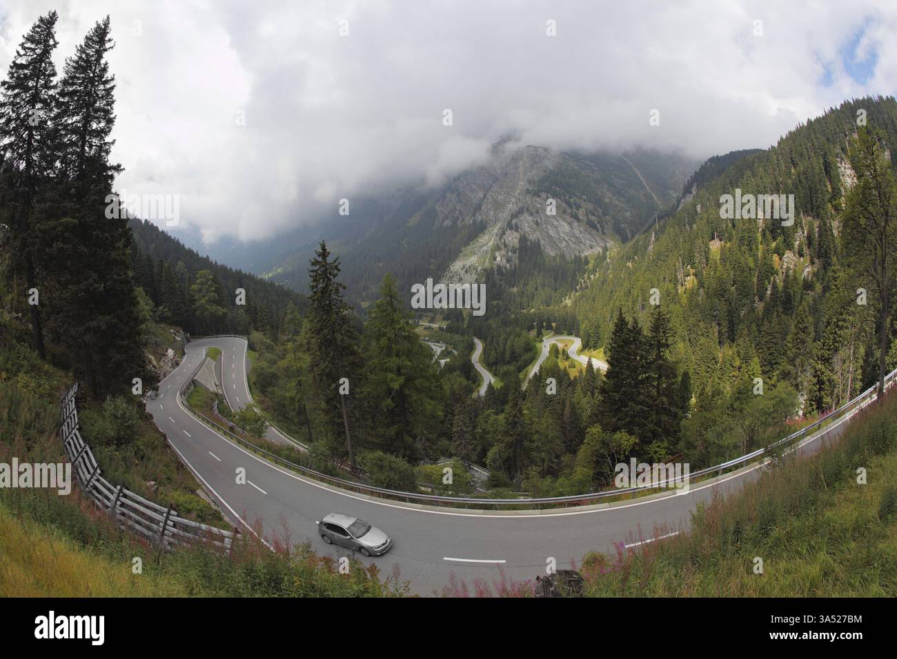 Cars on a steep bend in the road in the Italian Alps Stock Photo - Alamy