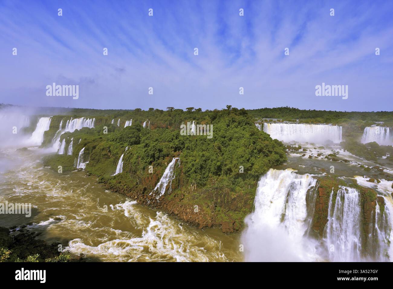 Roaring falls in South America - Iguazu. Foamy streams fall between the ...