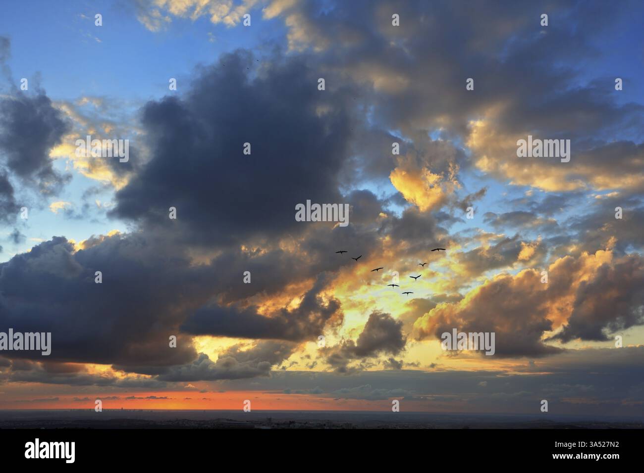 The magnificent sunset over the Adriatic Sea. Flying Triangle flock of ...