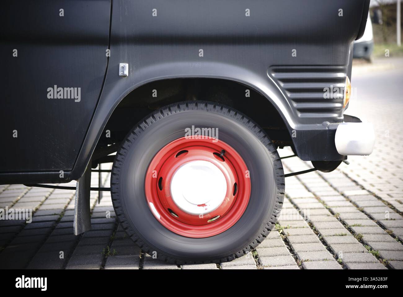 The side view and close-up of the front wheel of an old Ford Caravan ...