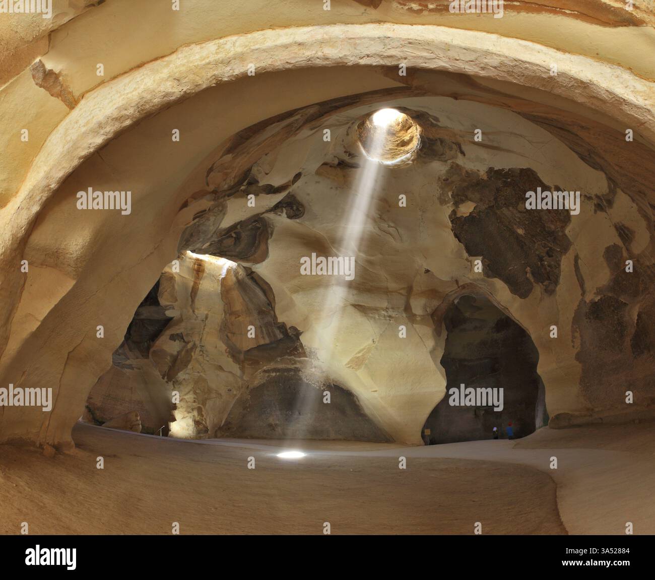 Clay huge caves are picturesquely shined with the sun from an opening ...