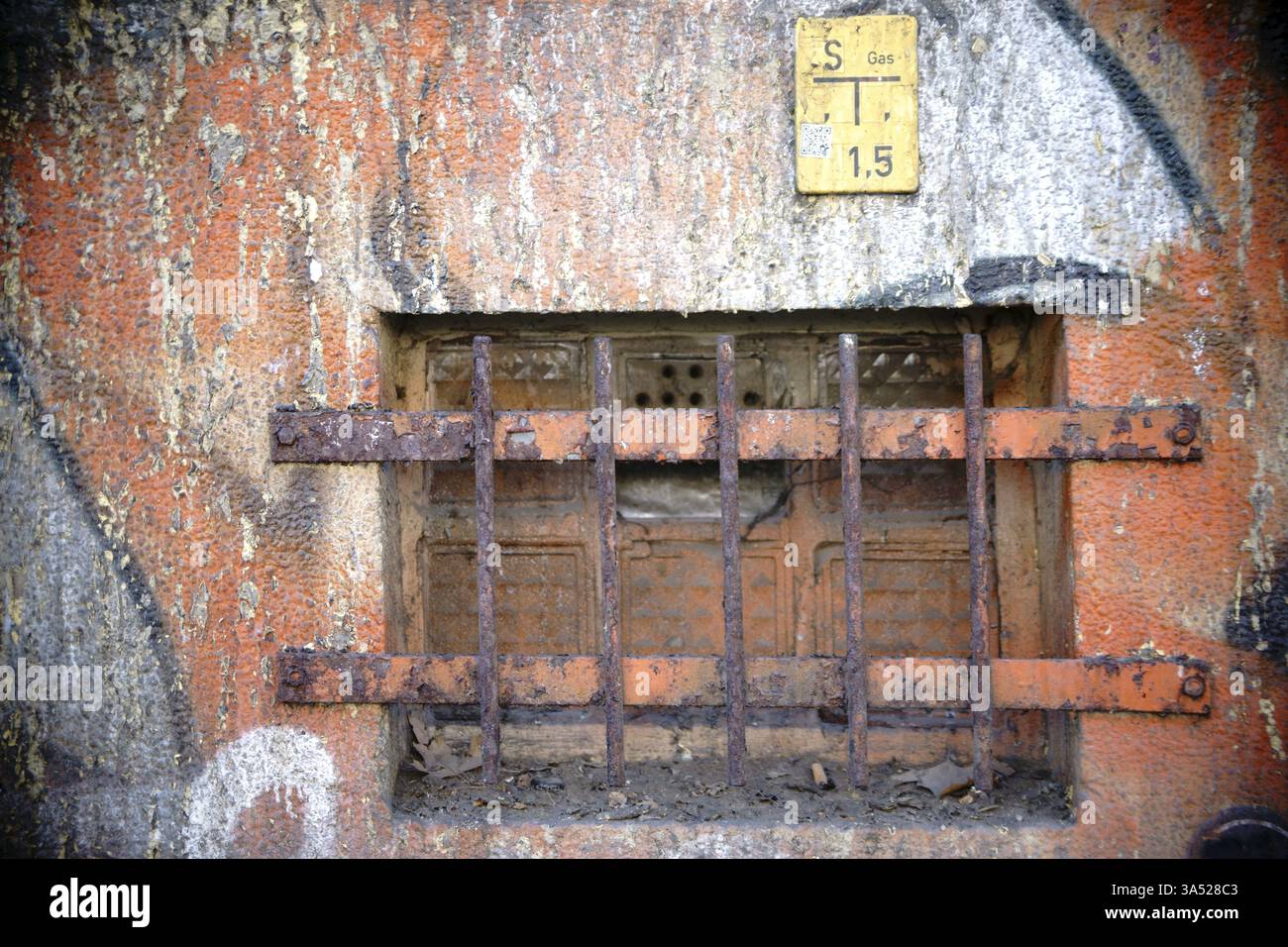 A close-up of a colourfully painted cellar hatch made of glass tiles ...