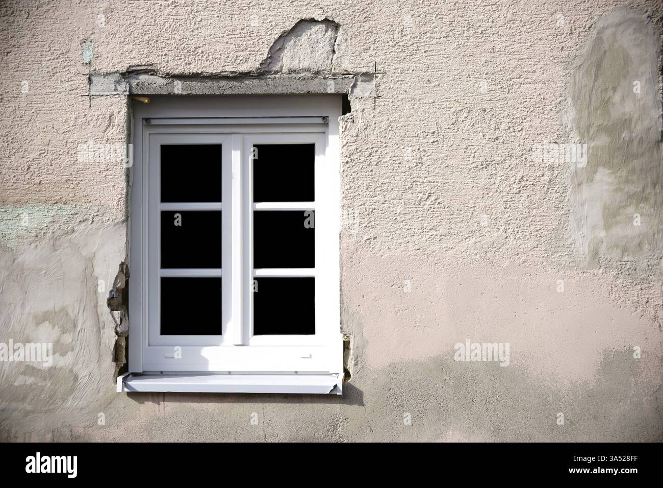 The facade of a house in need of renovation with a newly installed ...