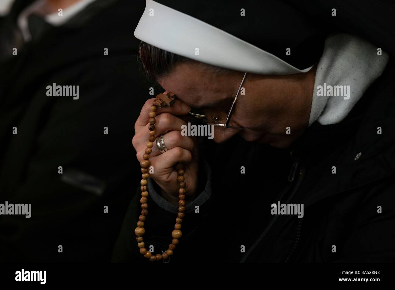 A nun prays as she attends a rosary prayer for Pope Francis' health in St. Peter's Square at the ...