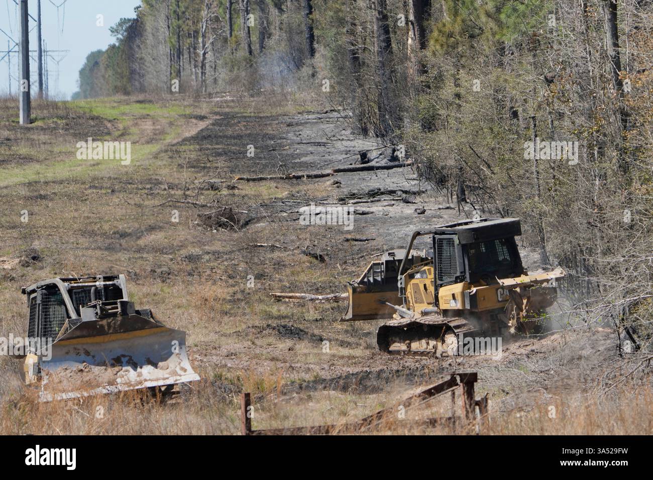 Fire crews drive along a fire line while working to contain the Pauline ...