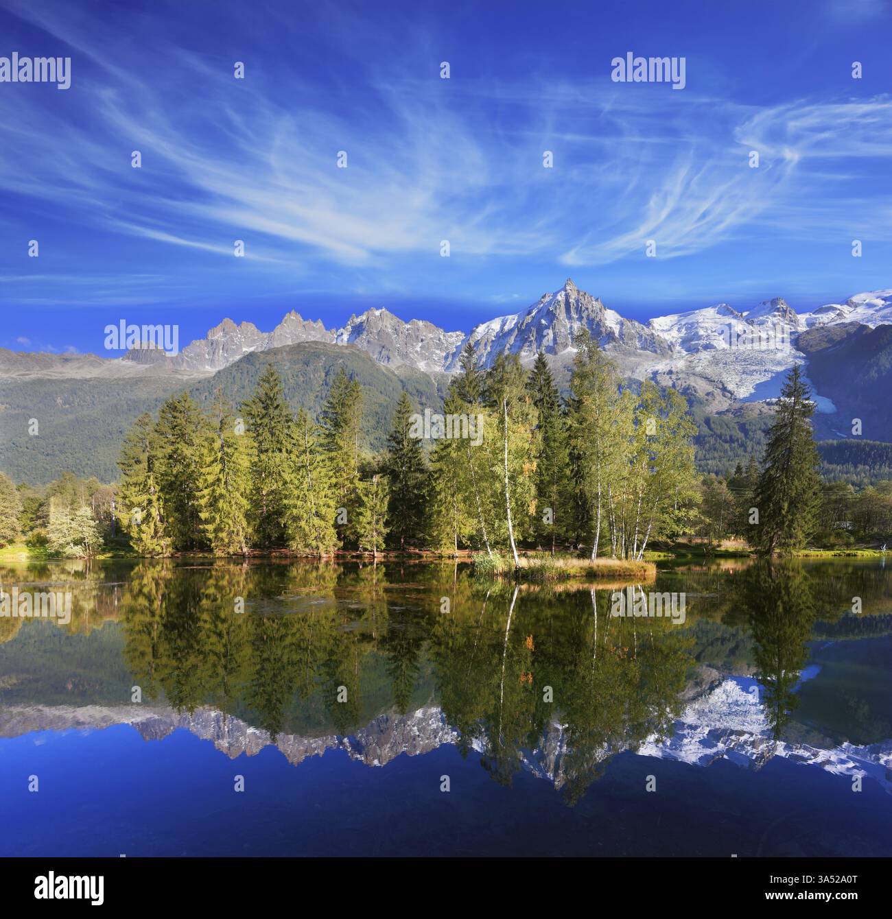 Dreamlike beauty lake and park. In smooth water reflected snow-capped ...