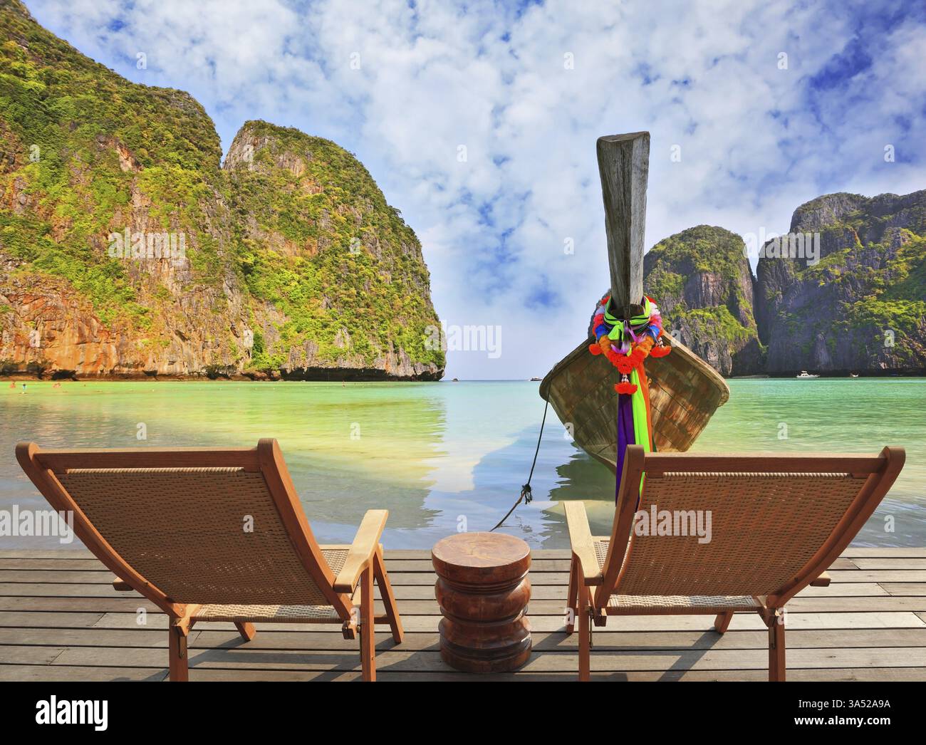 Two wooden chaise lounges and small bedside table on a wooden scaffold ...