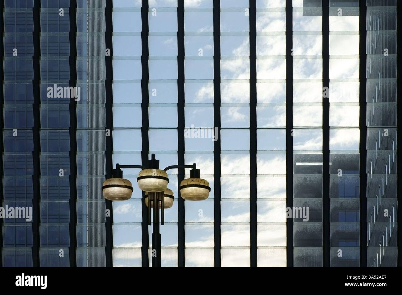 A glass facade with rows of hinged windows in front of which a lantern ...