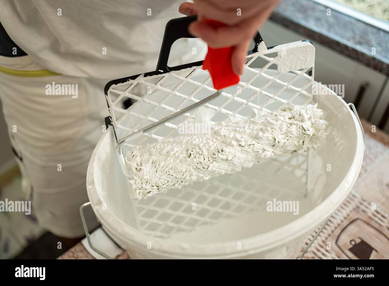 Person using roller apply white hi-res stock photography and images - Alamy